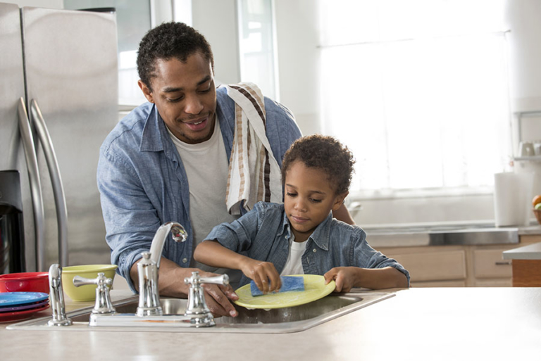 Father & son washing dishes – Sandra Rose