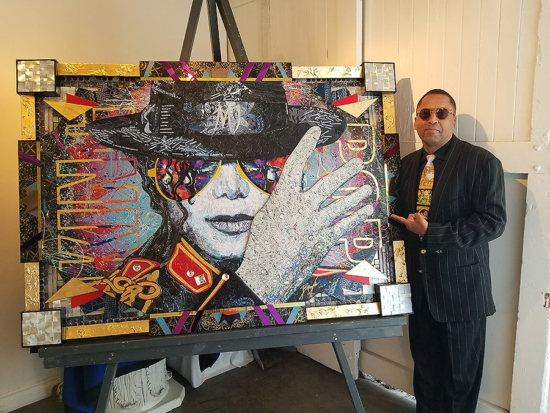 Keith Holman poses with artist Kenneth Brayden Matthews’ MJ portrait at ...