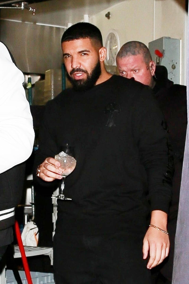 Drake brings the party outside with a drink in hand while leaving The ...