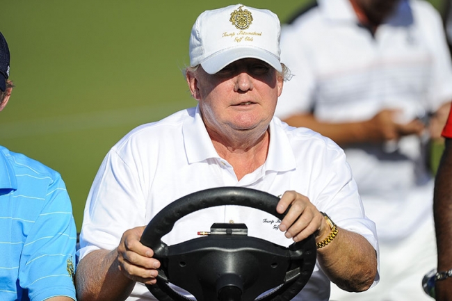 Businessman Donald Trump drives a golf cart during the second round of ...