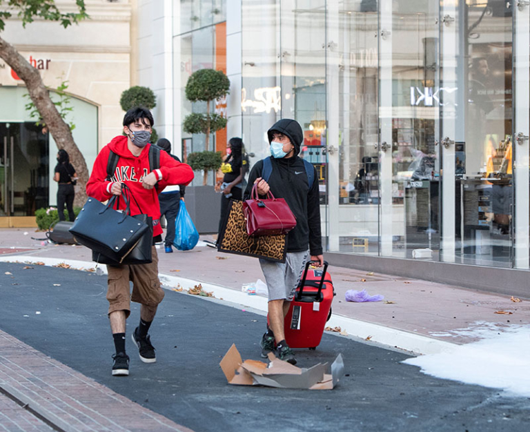 People are seen looting stores at the Grove shopping center in the ...