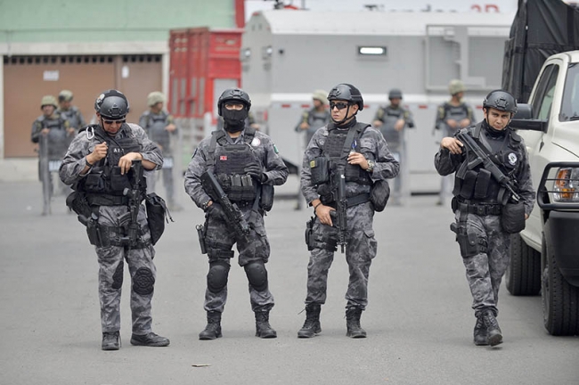 Special Operations Group (GOPES) officers mount guard in the scene of a ...